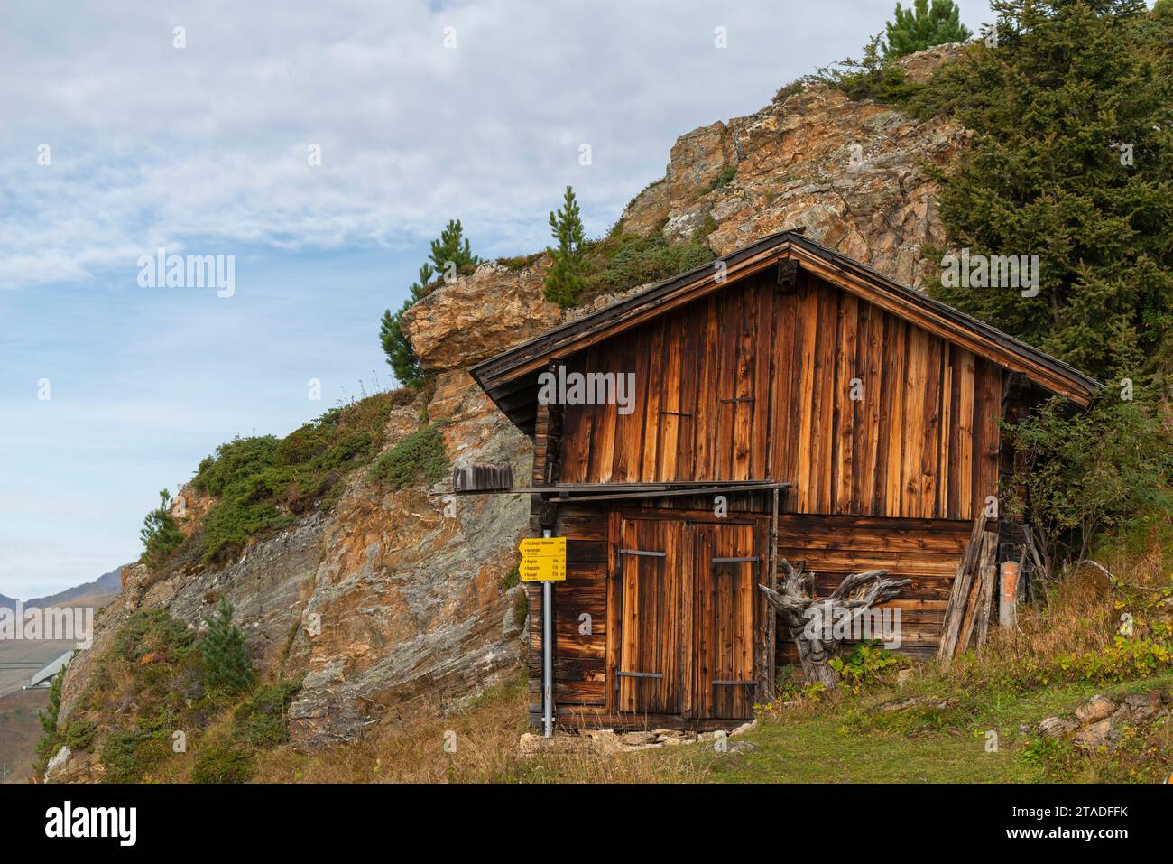 Wooden alpine hut with finger post indicating trails, Mount Penken ...
