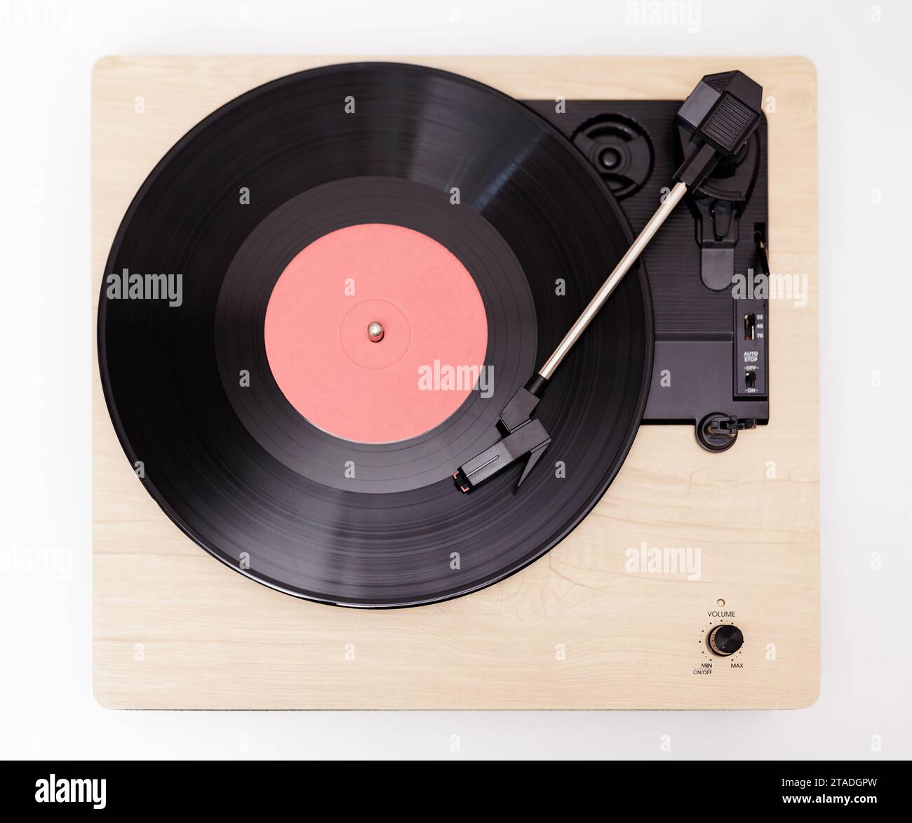 Top view of vintage portable record player playing a black vynil record ...