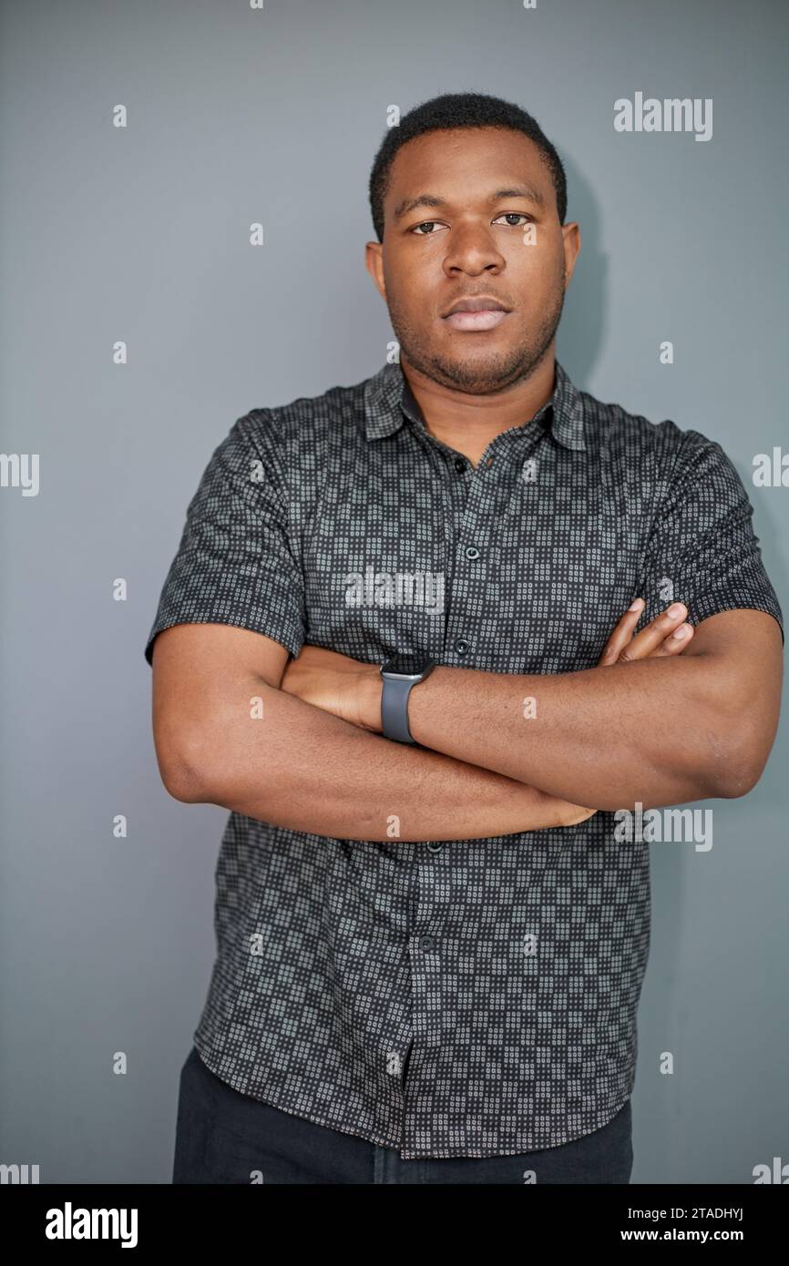 Portrait of an attractive cool guy on a gray background Stock Photo - Alamy