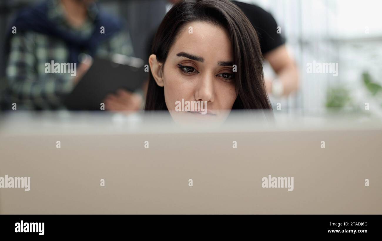 Young businessman typing email in the office on a laptop Stock Photo ...