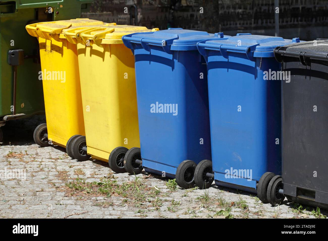Colourful various recycling bins and waste bins, standing on the street ...