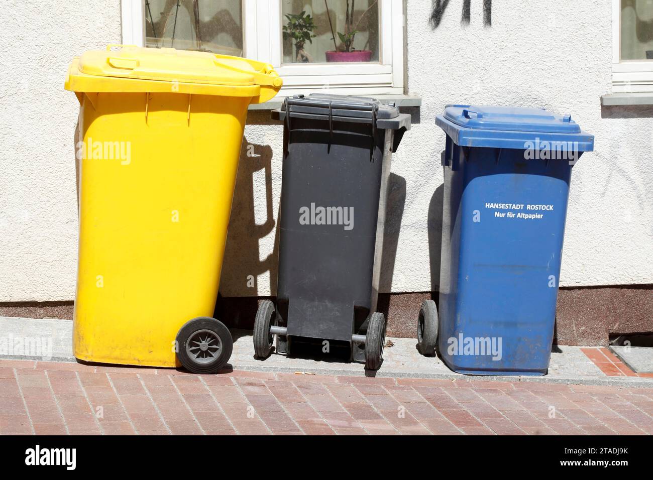 Colourful various recycling bins and waste bins, standing on the street ...