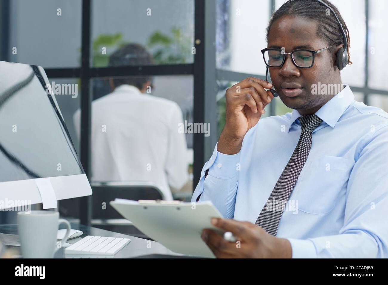 African man reading into microphone hi-res stock photography and images ...