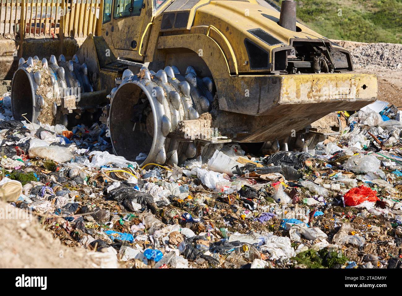 Heavy machinery shredding garbage in an open air landfill. Waste Stock ...