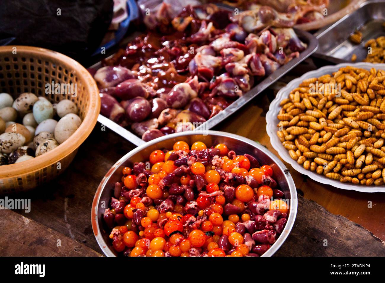 Chicken hearts, eggs, silkworm pupaes and various offal being sold at ...