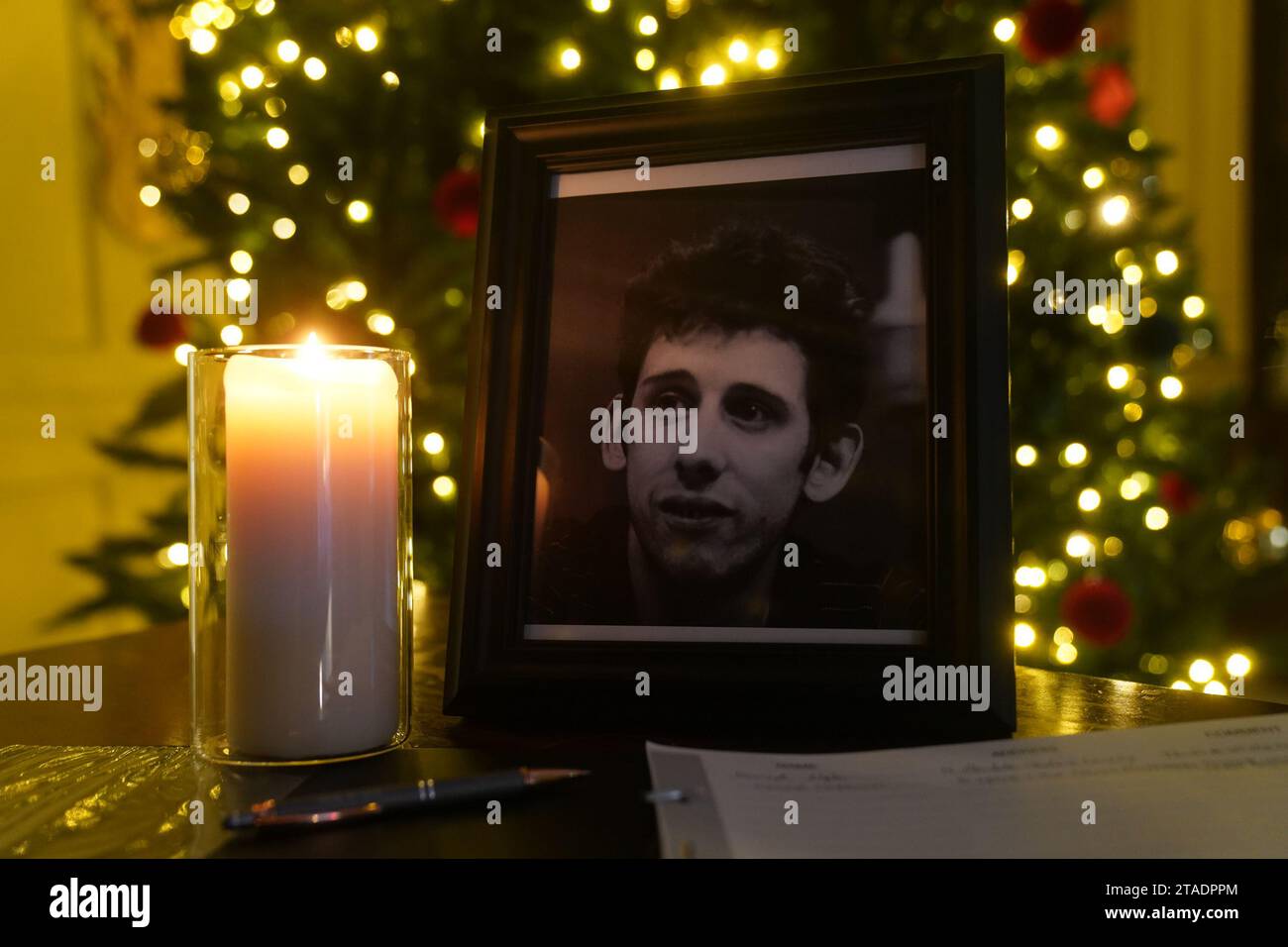A candle burns next to a photograph of The Pogues frontman Shane ...