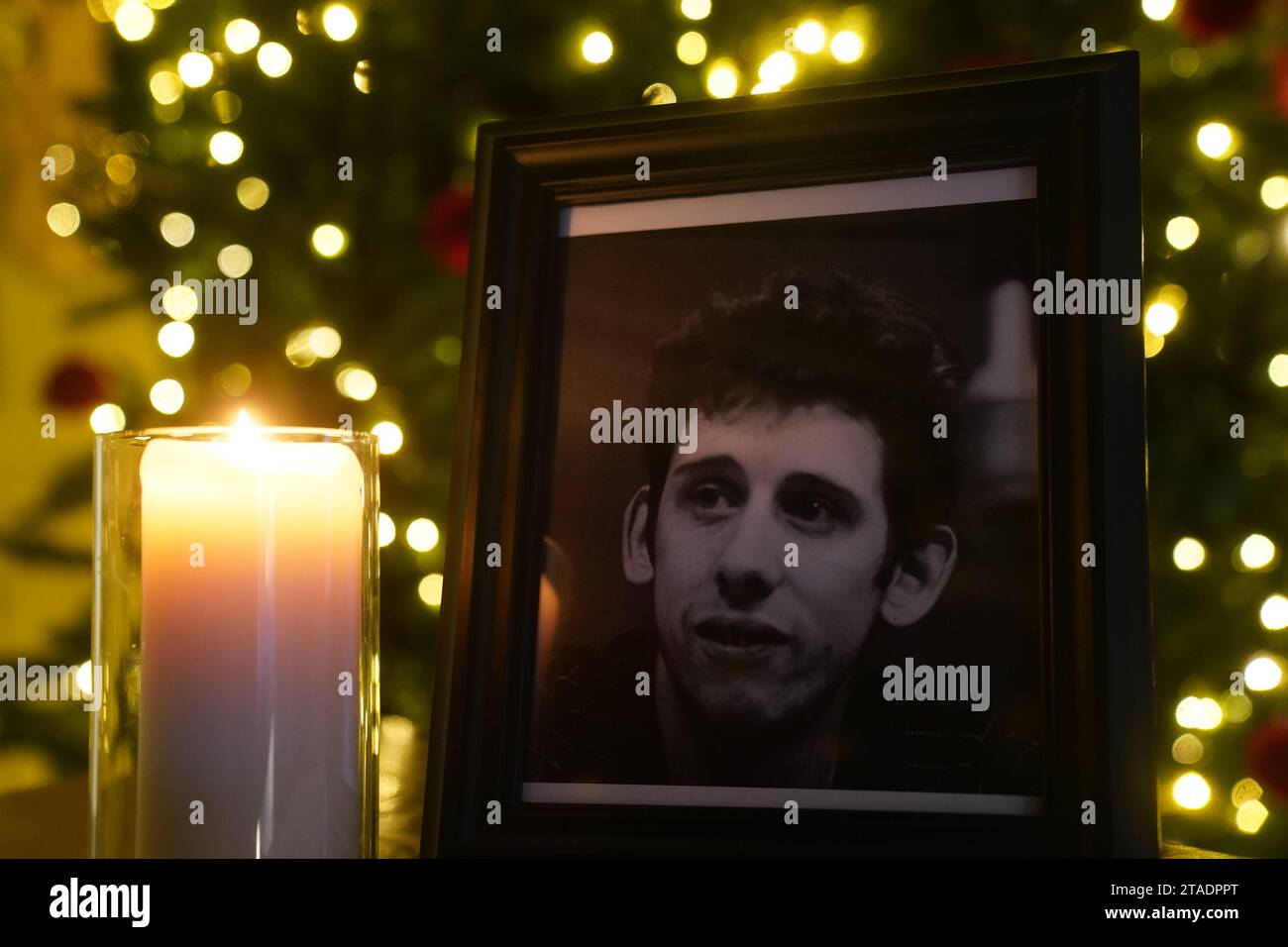 A candle burns next to a photograph of The Pogues frontman Shane ...
