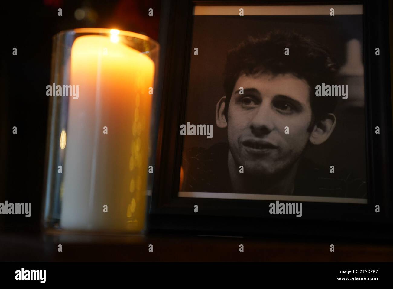 A candle burns next to a photograph of The Pogues frontman Shane ...
