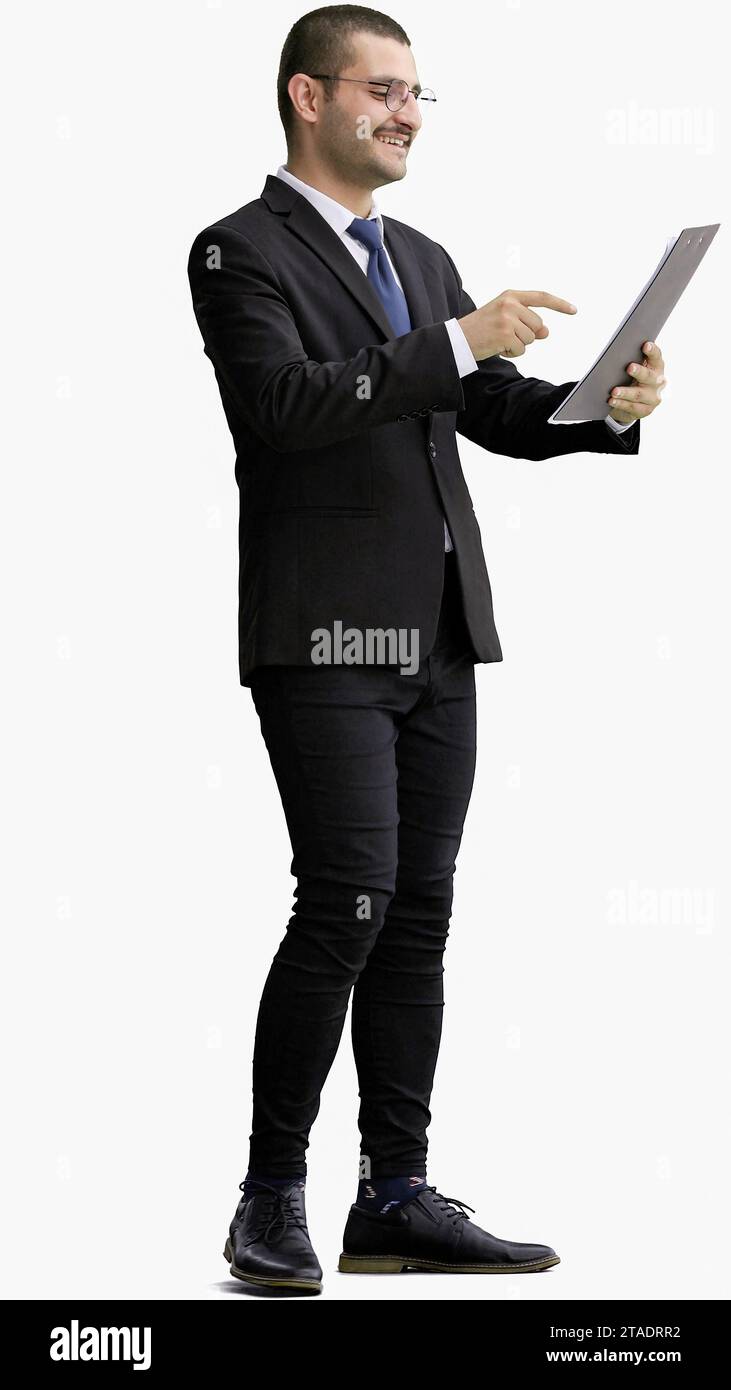 young man in full growth. isolated on white background looking at paper ...