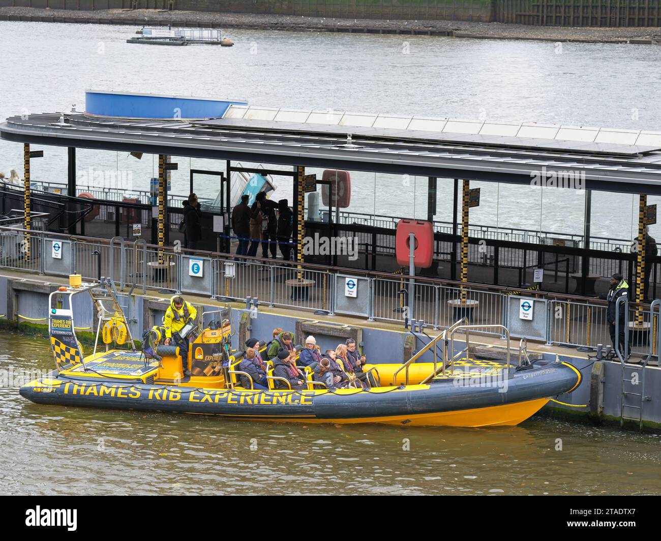 Passengers sit in the 'Thames Rib Experience' speed boat moored at ...
