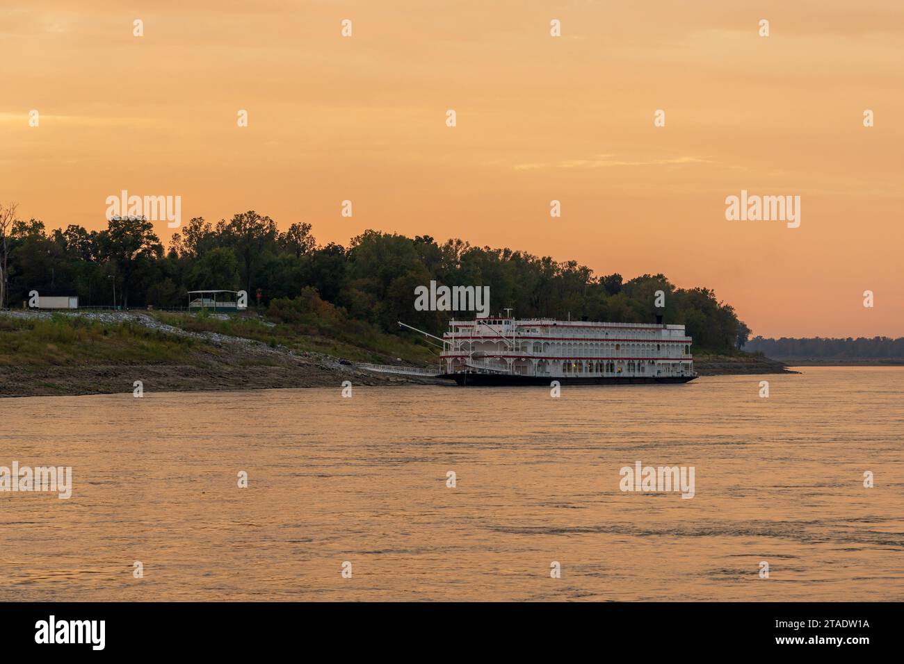 Old fashioned paddle steamer cruise boat docked by slipway in low water ...