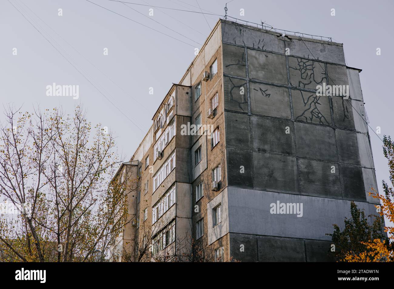 Old Soviet multi-storey residential building in gray color. Panel house ...