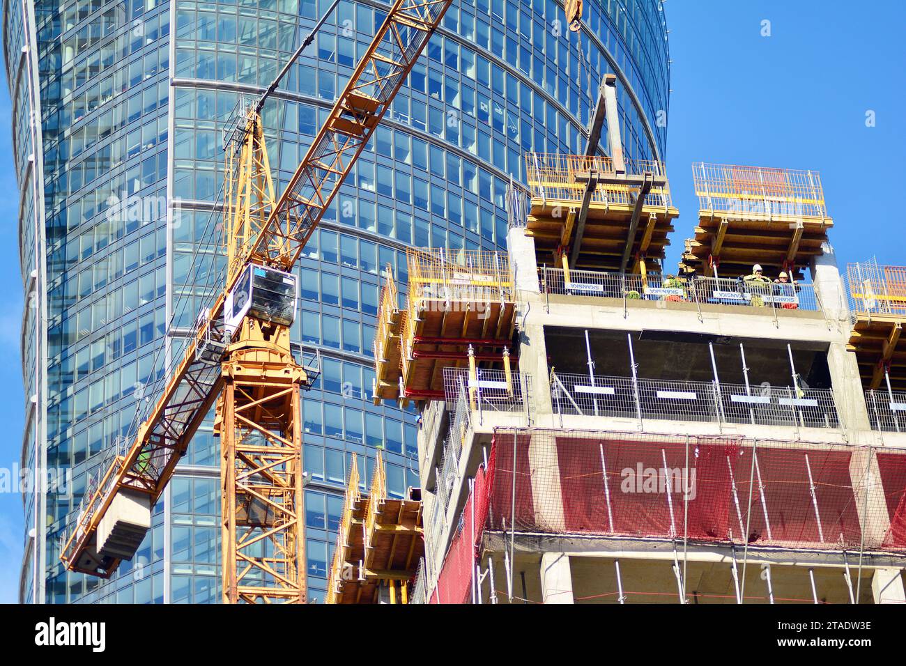 High rise building under construction. Installation of glass facade ...
