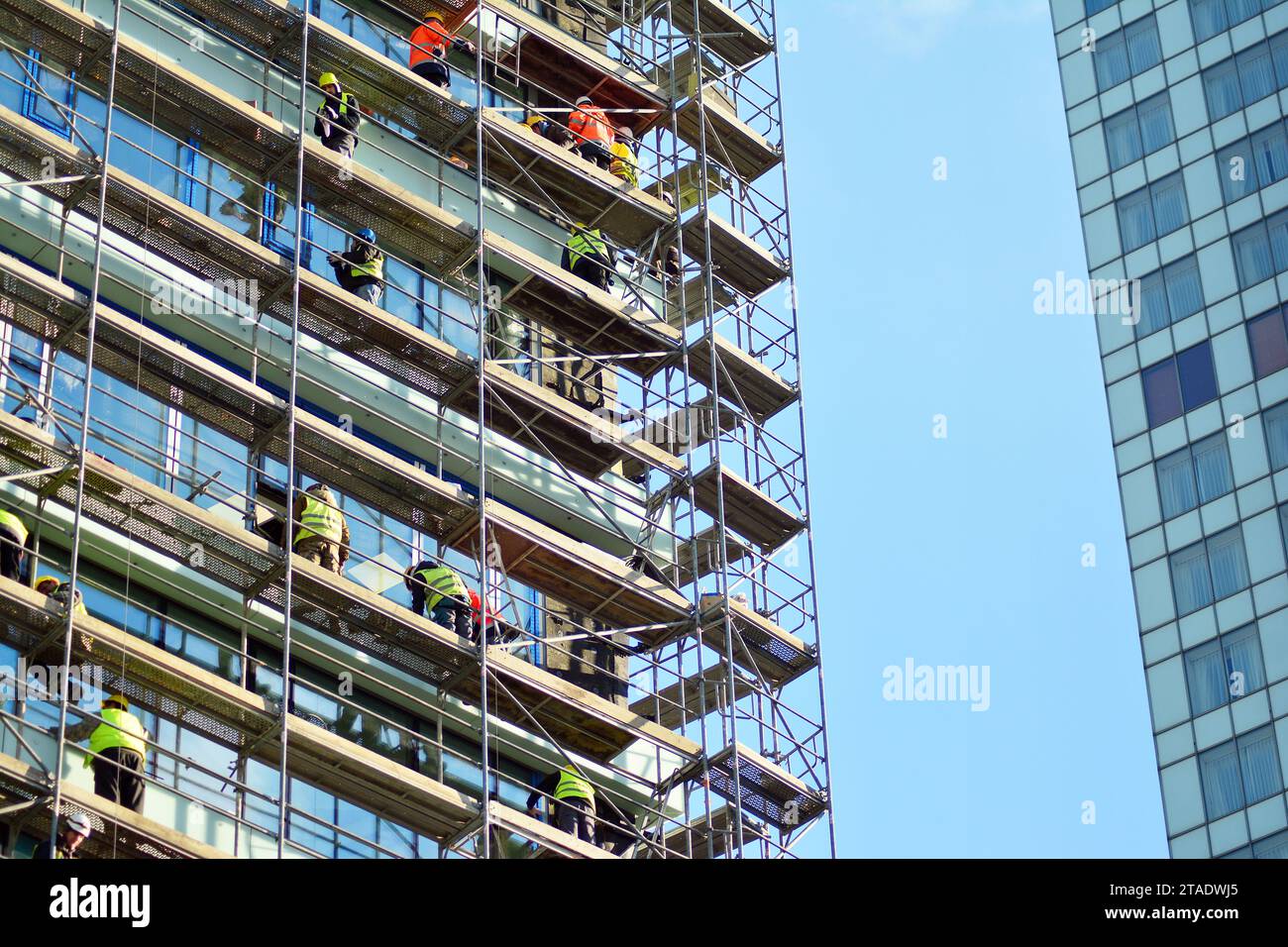 High rise building under construction. Installation of glass facade ...