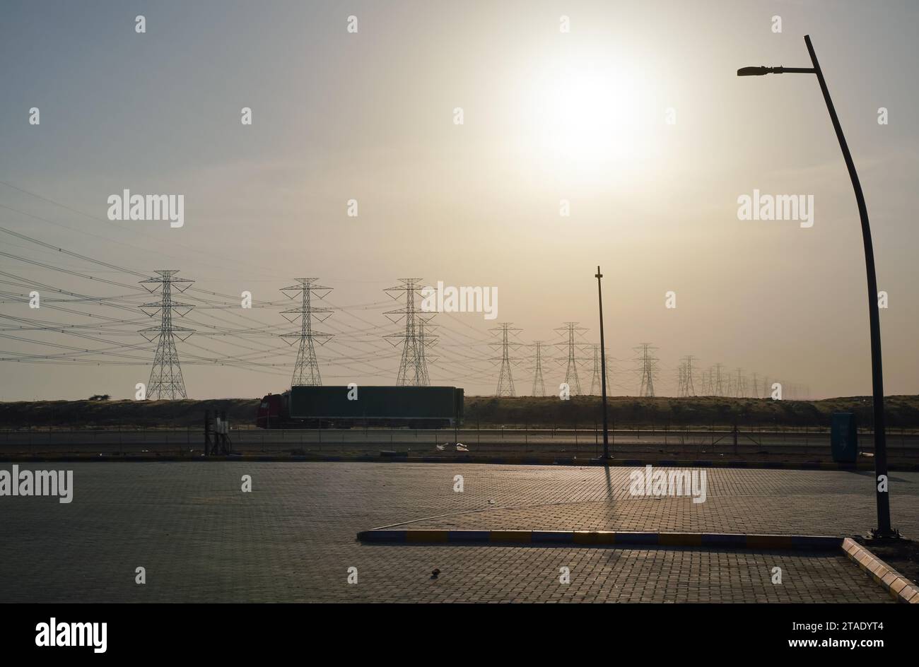Large tall steel power pylons in rather flat landscape of Saudi Arabia ...