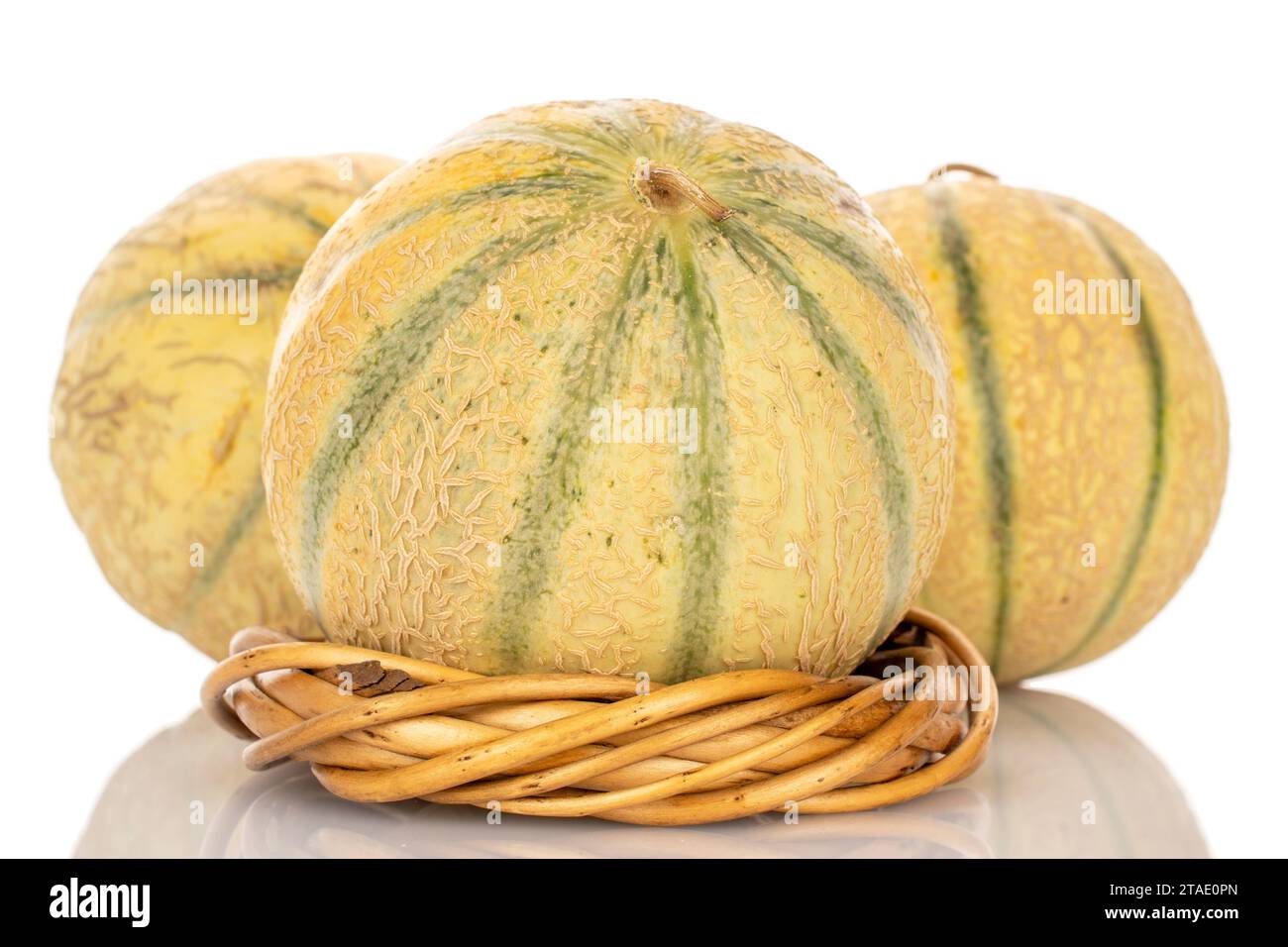 Three sweet cantaloupe melons with vine wreath, macro, isolated on ...