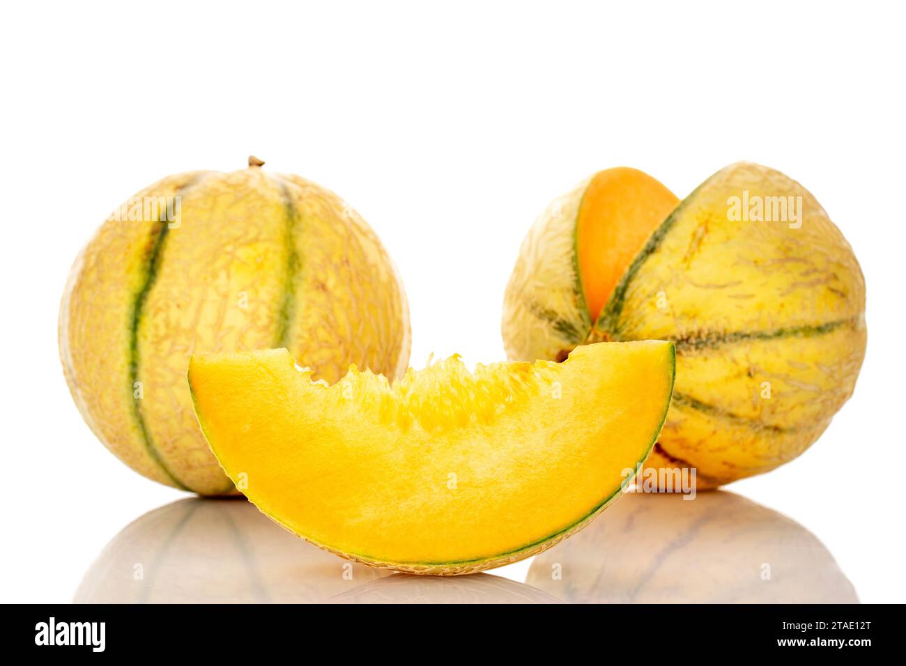 Two melons and one slice in focus, close-up, on a white background ...