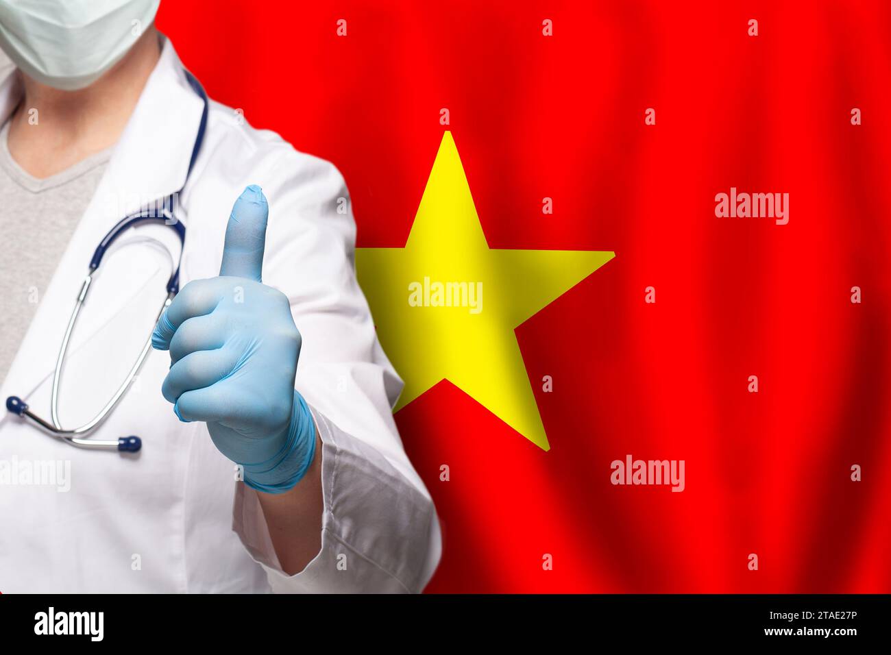 Vietnamese doctor's hand showing thumb up positive gesture on flag of ...