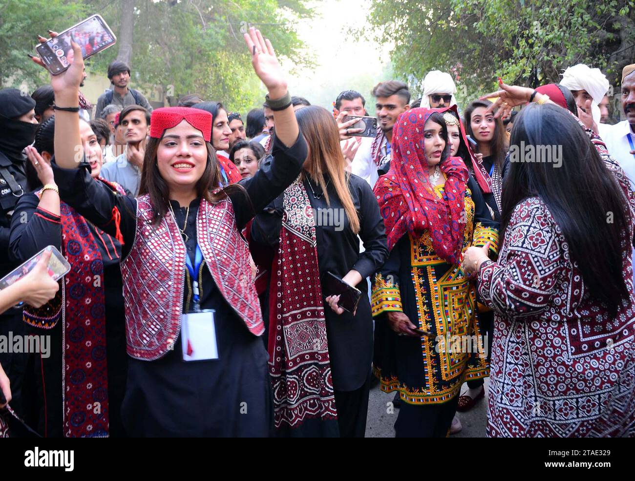 People are wearing traditional clothes as they are holding celebration ...