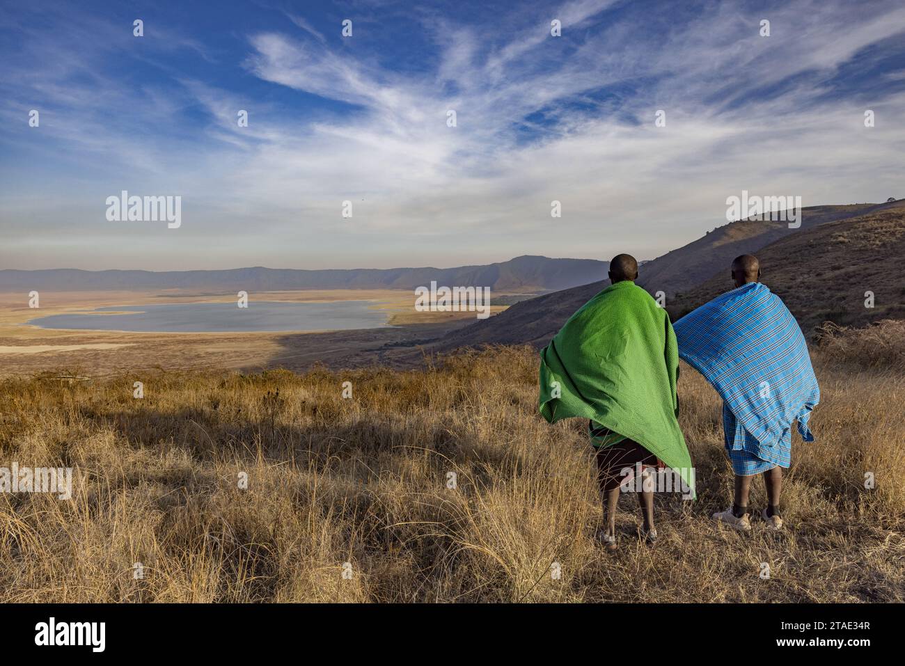 Tanzania, Arusha region, two Massai in traditional clothing look at the ...