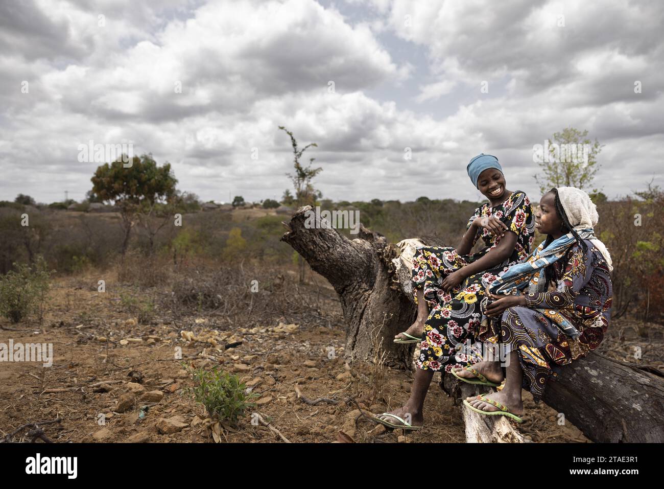 Tanzania, Ruvuma region, Jakika, portrait of two young girls sitting on ...