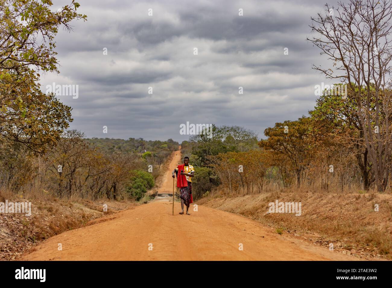 Tanzania, Ruvuma region, a man in traditional clothing with his mobile ...