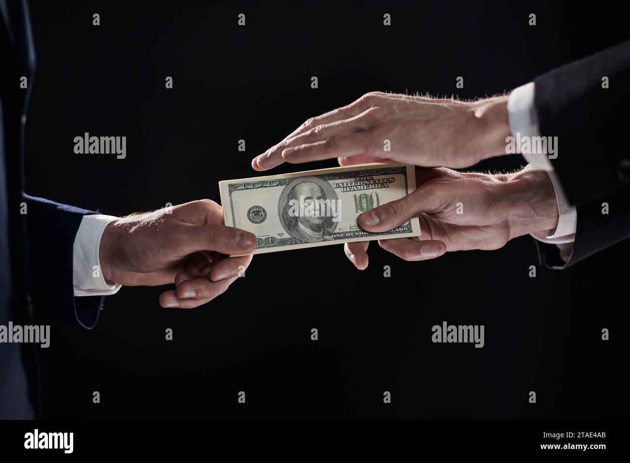 transferring money from hand to hand on a black background Stock Photo ...