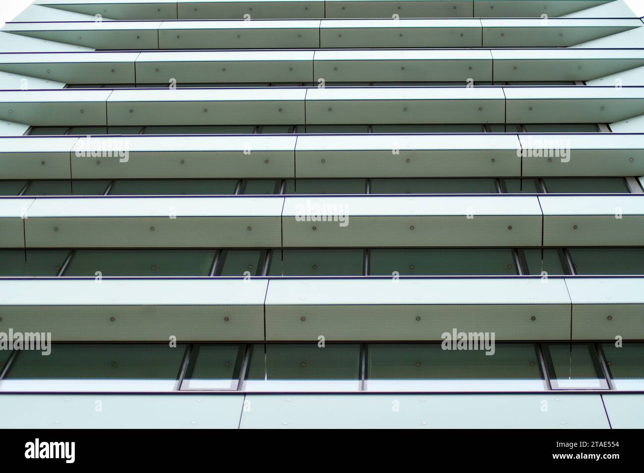 Modern office building with white metallic panel facade and windows ...