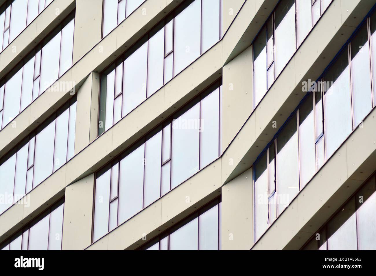 Modern office building with white metallic panel facade and windows ...