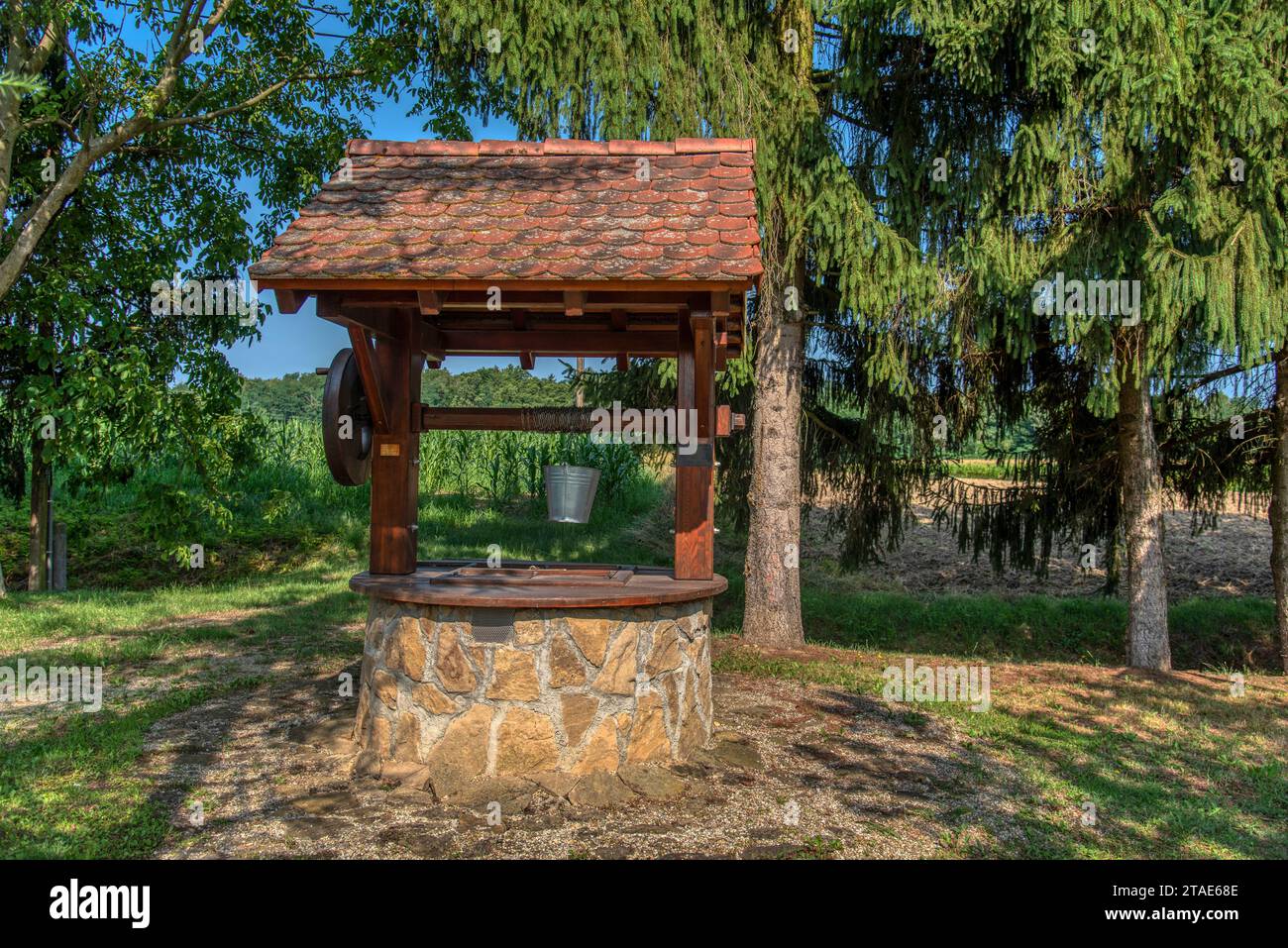 Rustic stone well with bucket and drinking water, Radenci, Slovenia ...