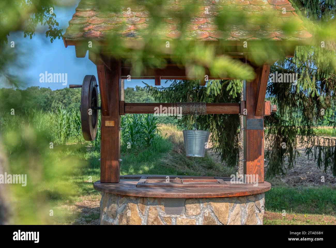 Rustic stone well with bucket and drinking water, Radenci, Slovenia ...