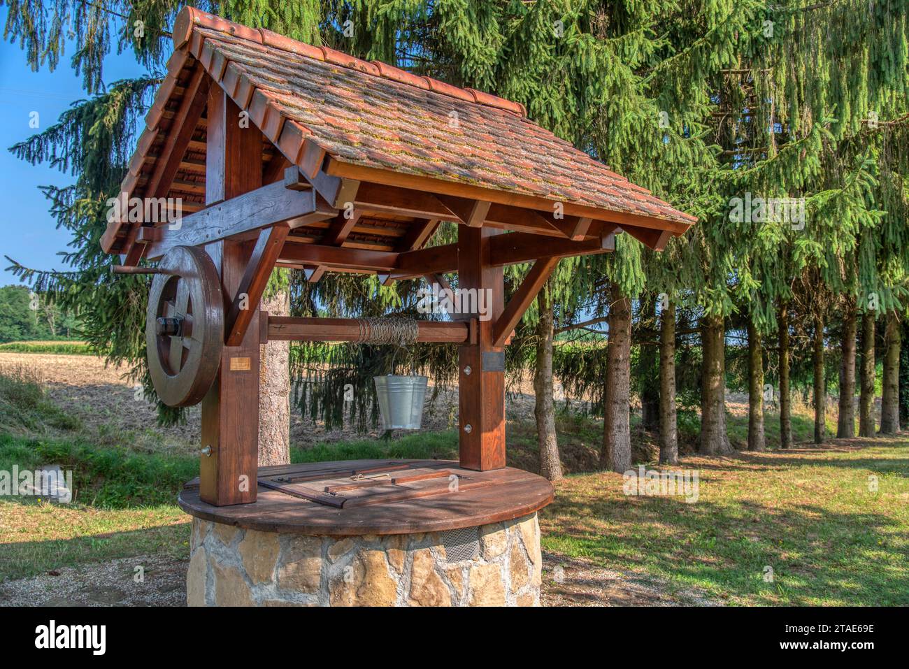Rustic stone well with bucket and drinking water, Radenci, Slovenia ...