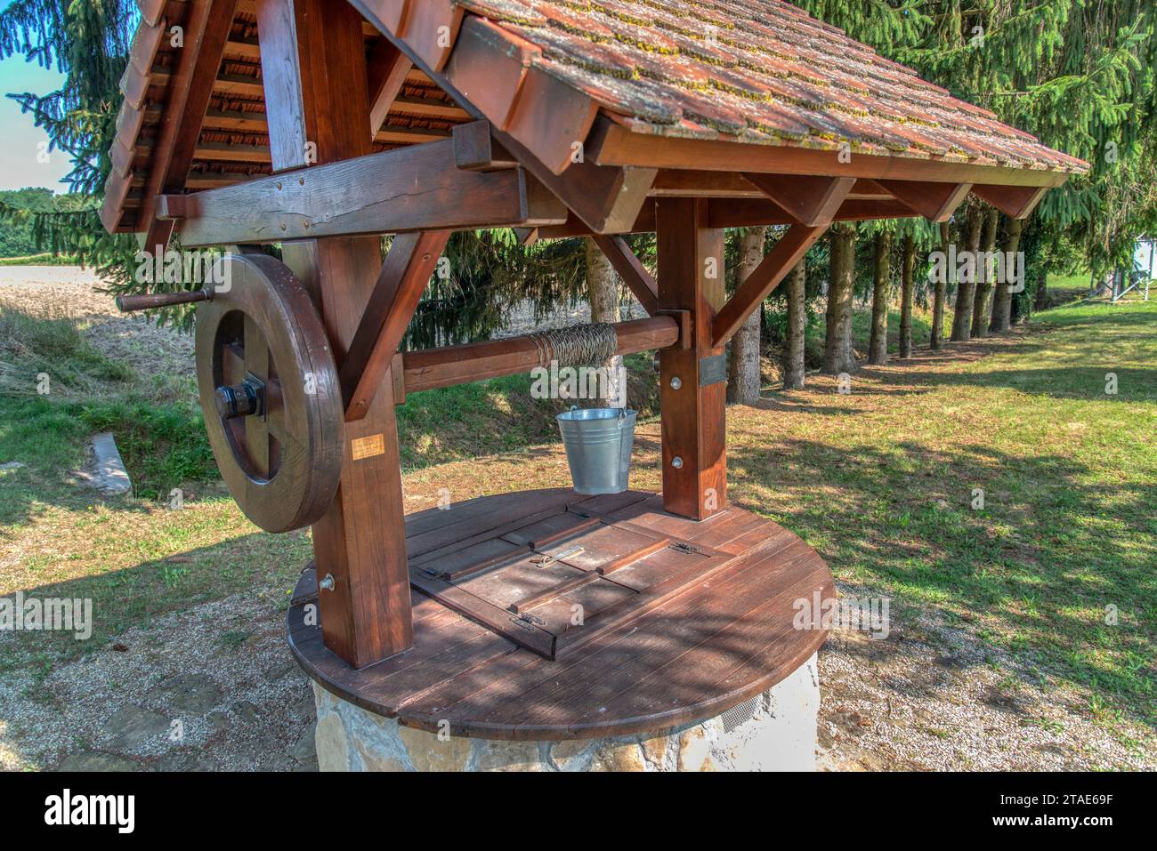 Rustic stone well with bucket and drinking water, Radenci, Slovenia ...