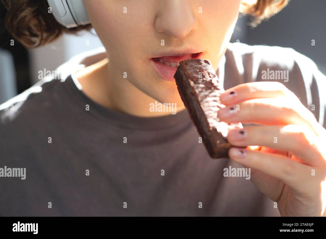 Woman eats chocolate bars snack between work. Unhealthy food Stock ...