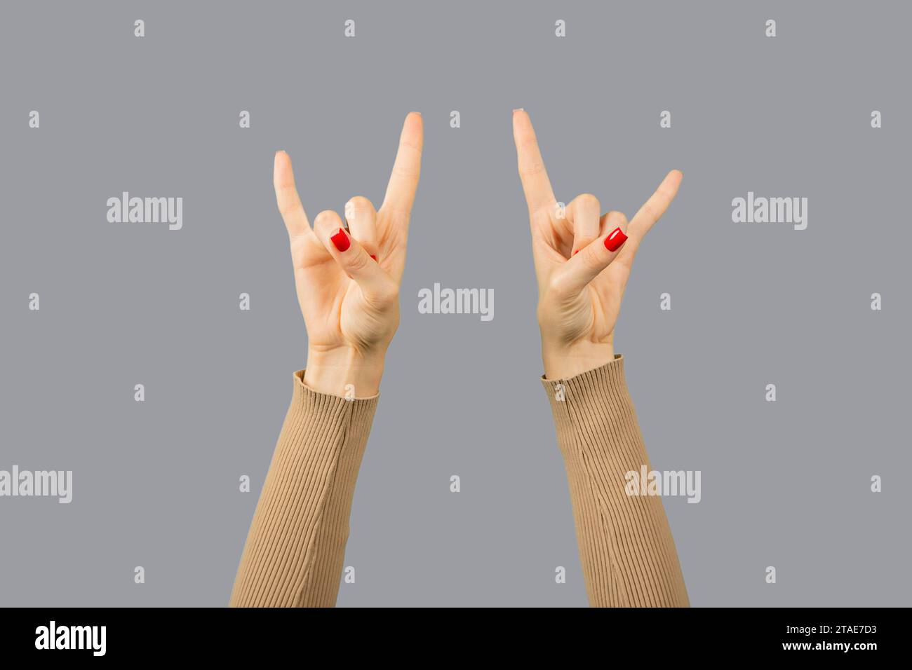 Signs of horns from two female hands isolated Stock Photo - Alamy