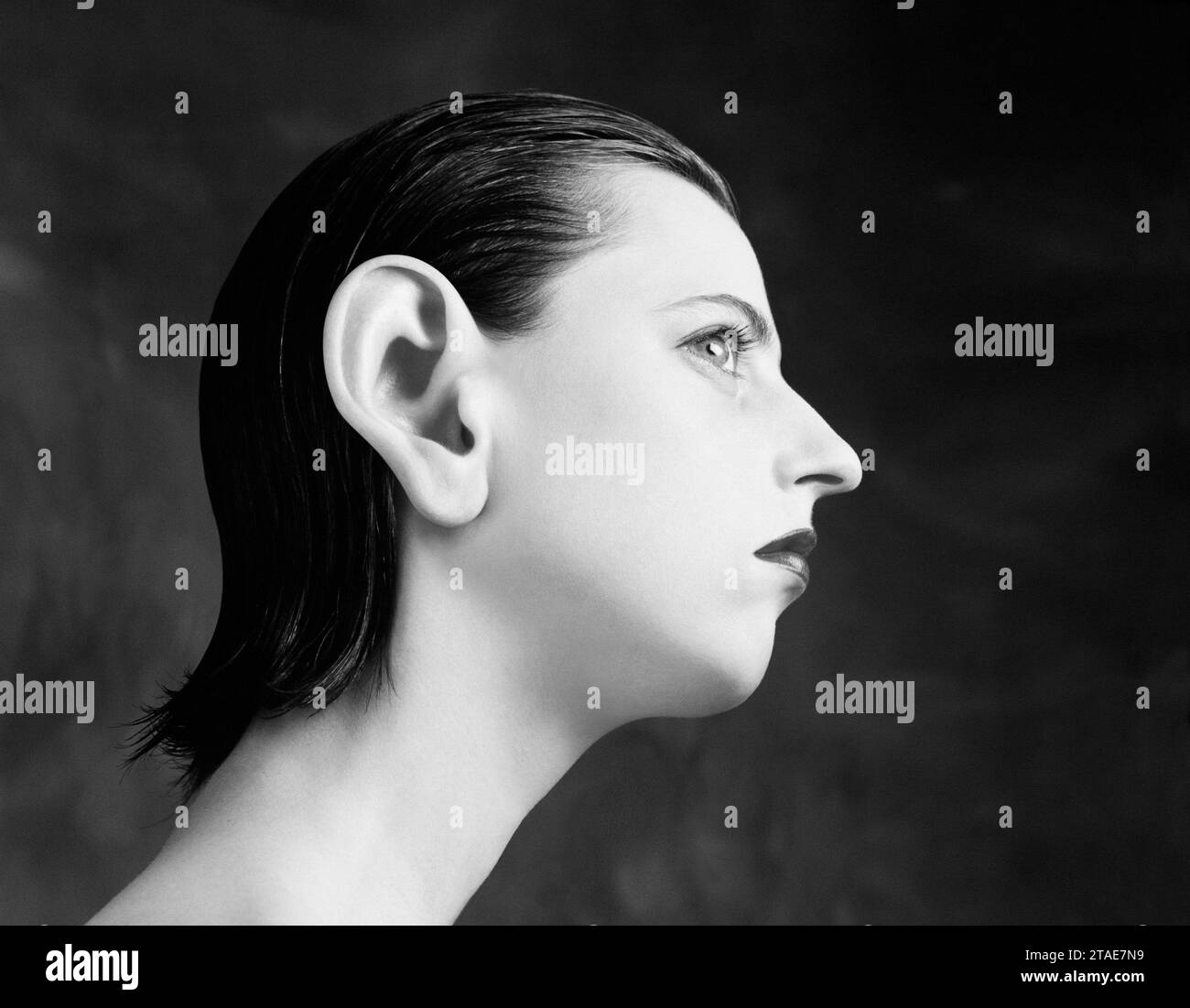 Young woman in profile with large ear, listening Stock Photo - Alamy