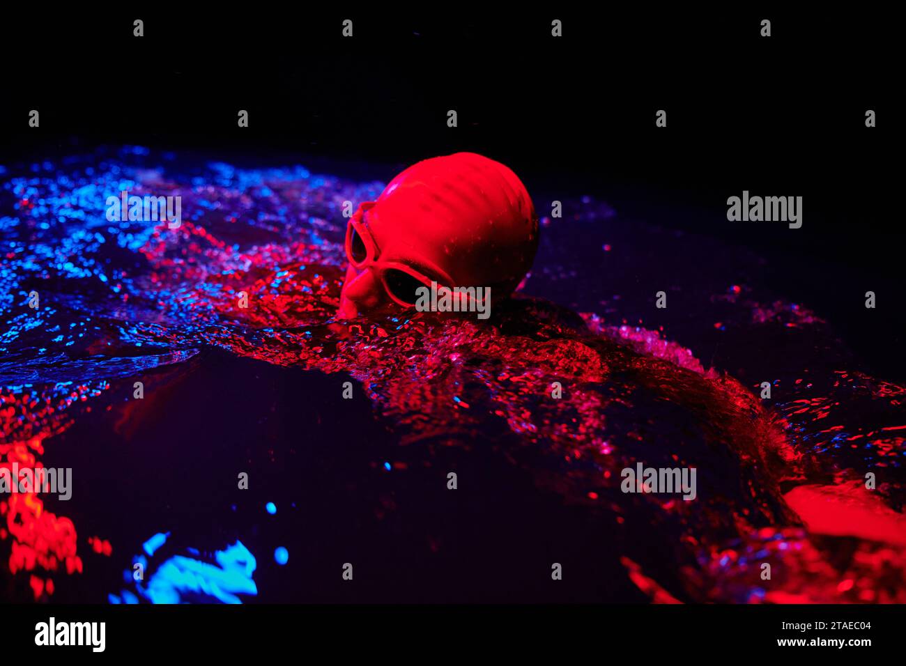 authentic triathlete swimmer having a break during hard training on ...