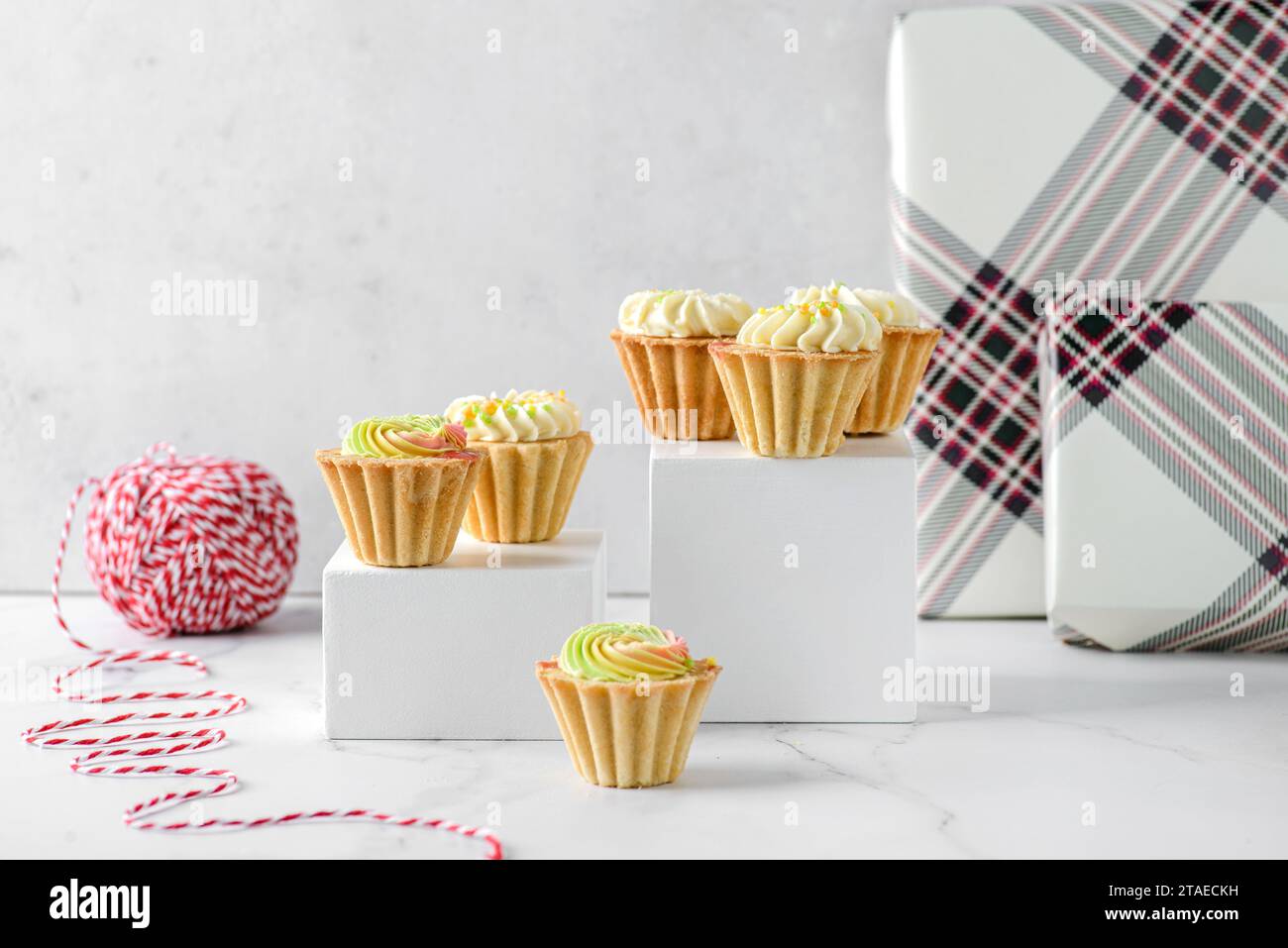 christmas mini cream cakes on a light background in shortbread tartlets ...