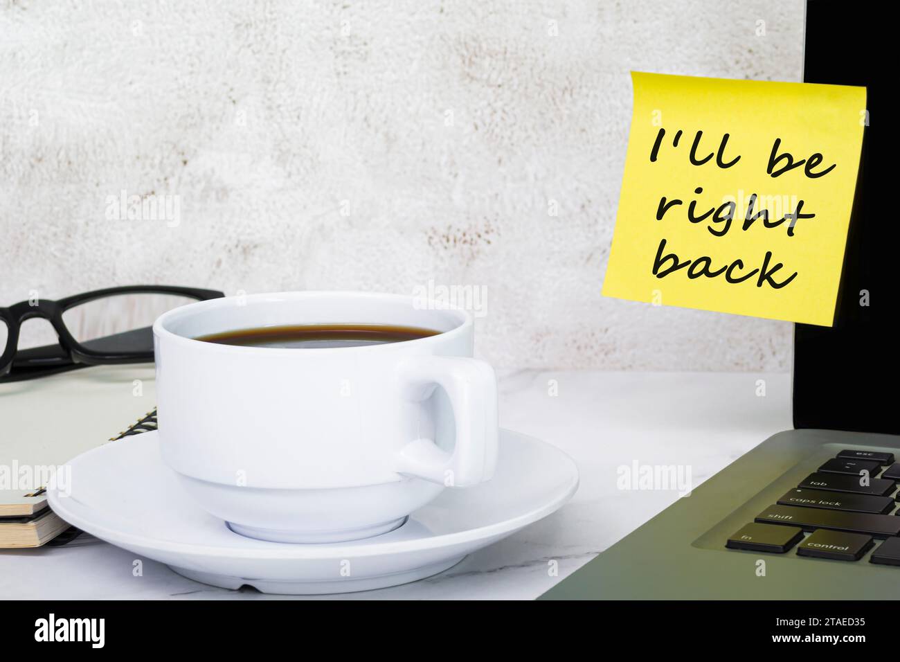 I'll be right back written on a yellow sticky note at the office Stock ...