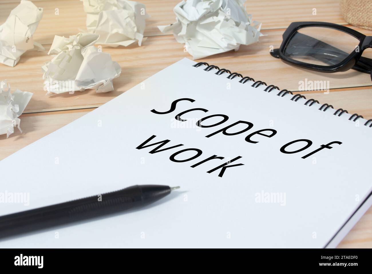 Scope of work written on notepad with trash paper background on office ...