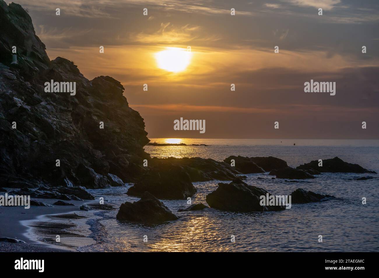 Spectacular sunrise on the sea between rocks, cliffs and calm waters ...