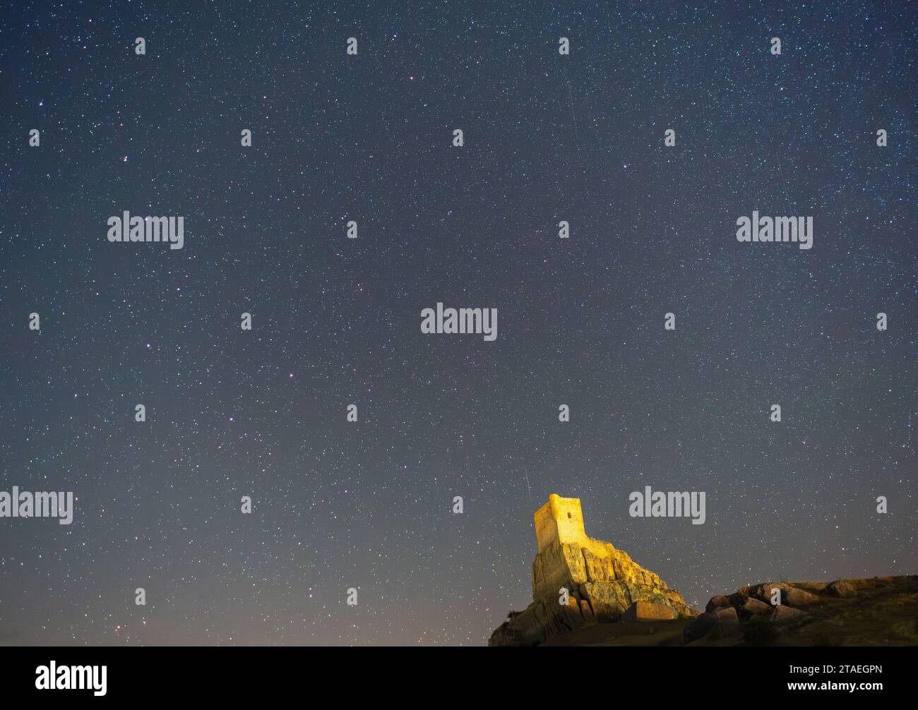 Atienza Castle illuminated in the darkness of the night with the Milky ...