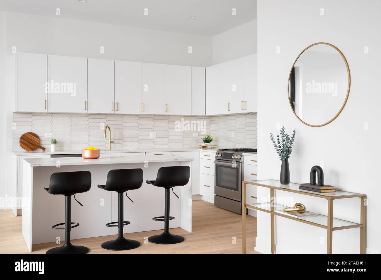 A kitchen detail with white cabinets, a picket tile backplash, white ...