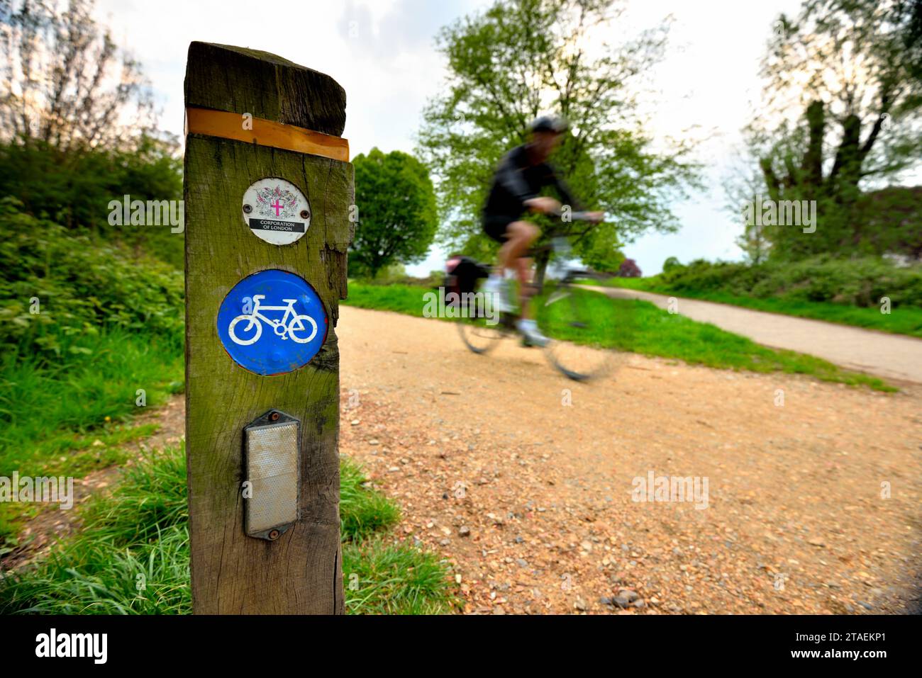 A man cycles along one of the gravel paths in Hampstead Heath in North ...
