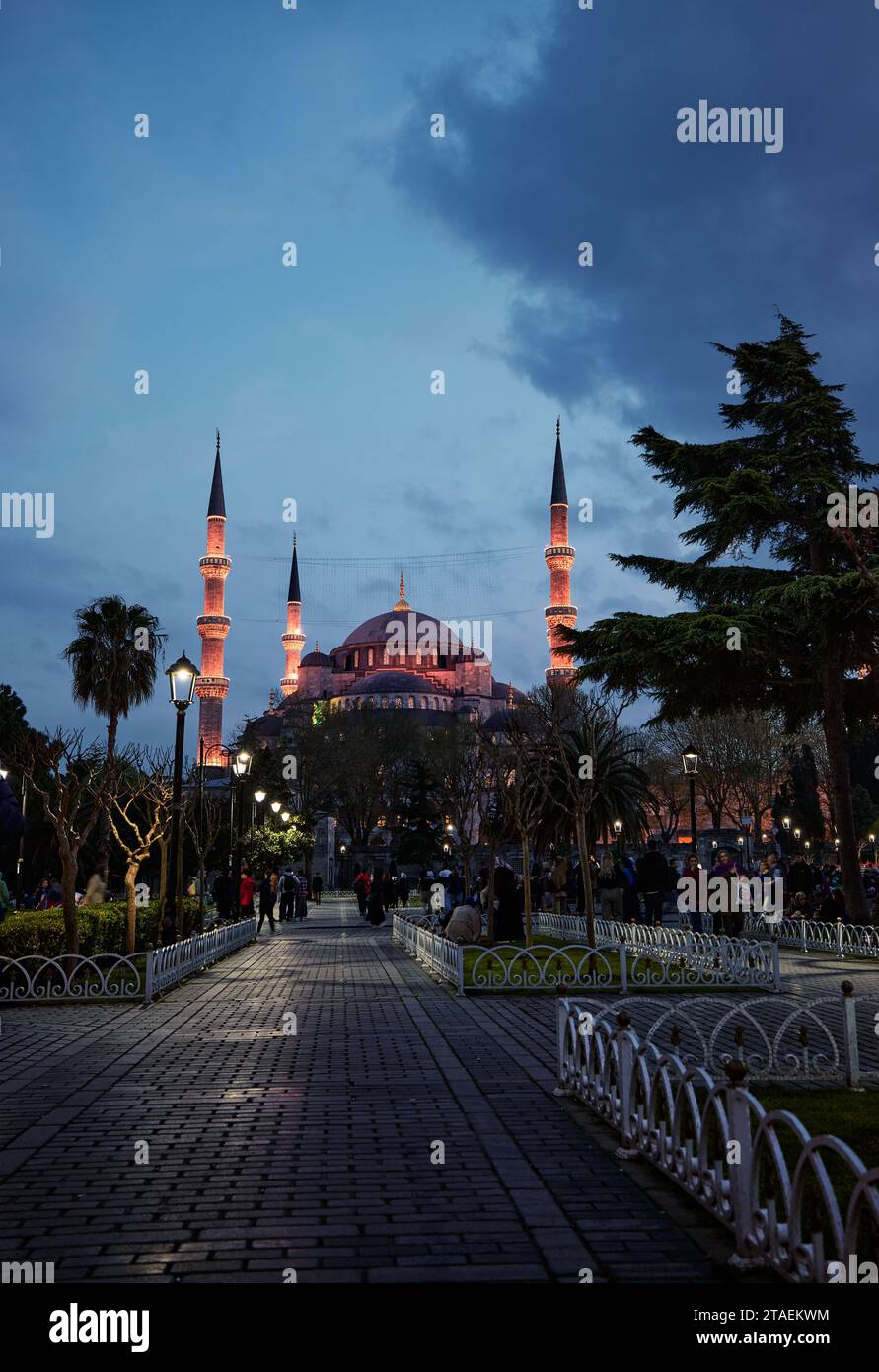A stunning view of the iconic Blue Mosque illuminated by the warm red ...