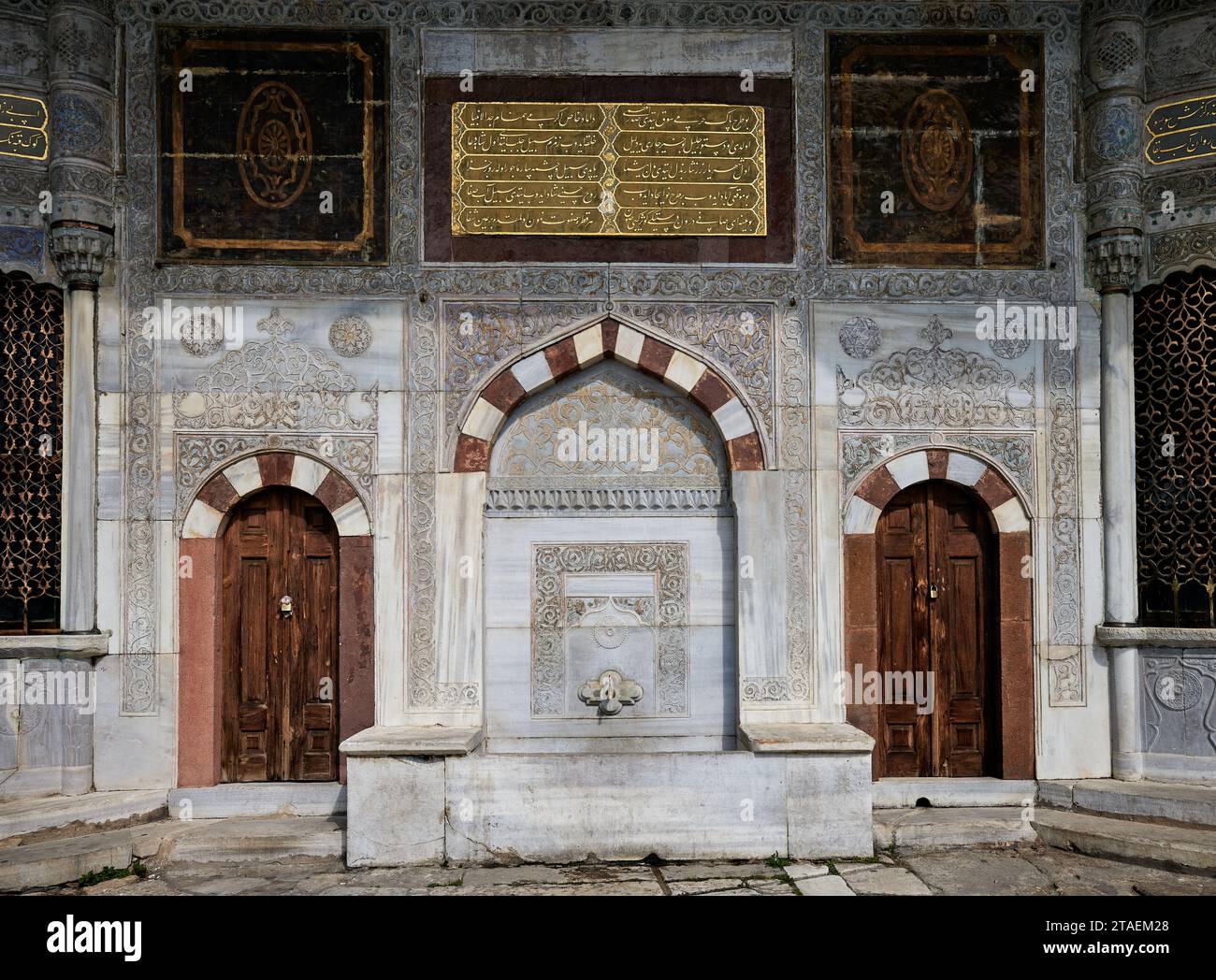 A stone and wood constructed building featuring a tiled archway and ...