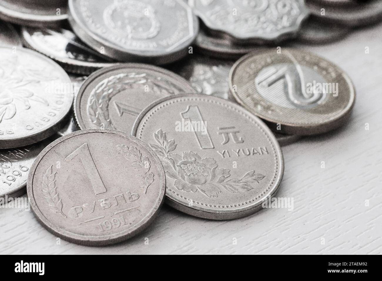 Coins of the Russian ruble, Chinese yuan, and other various coins close ...