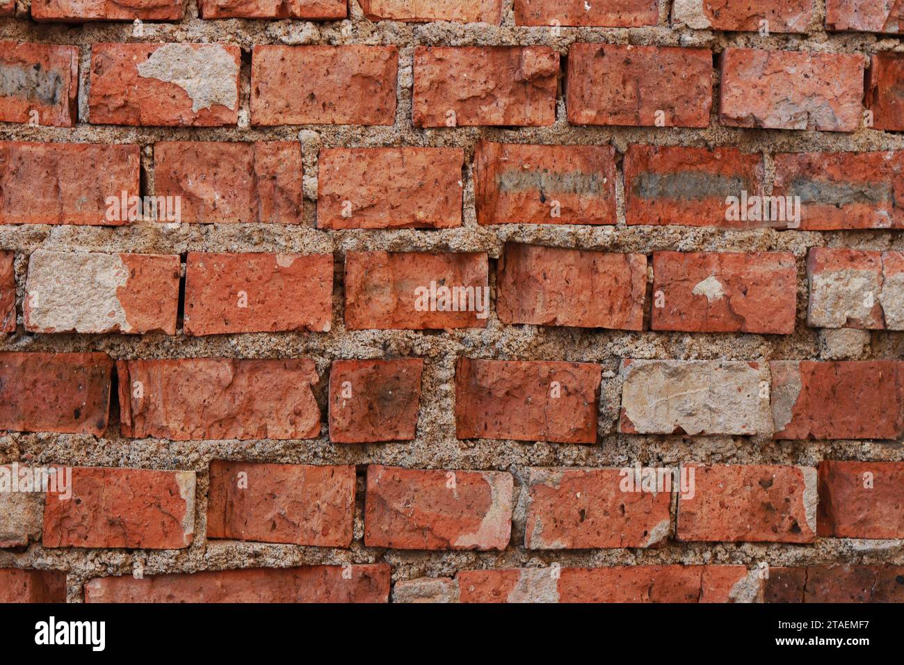 Red-brown plastered brick wall with chipped stucco. Red textured brick ...