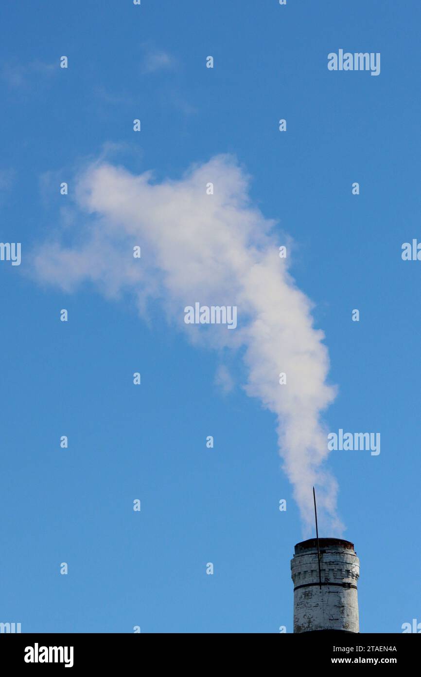 Carbon Emissions Concept. Rusty chimney. against the background of a ...