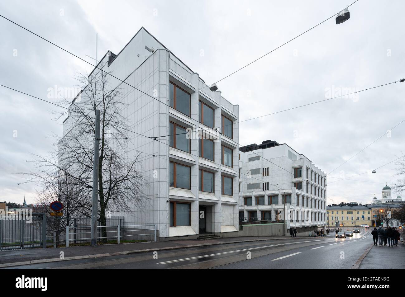 A modern, high-rise commercial building with an exterior of light brown ...